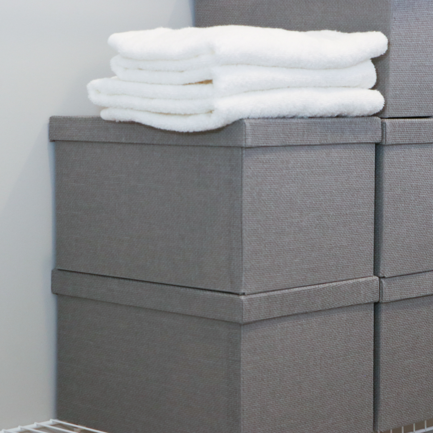 Grey Fabric Shoe Storage Cubes with Bath Linens and Clothes Hangers ...