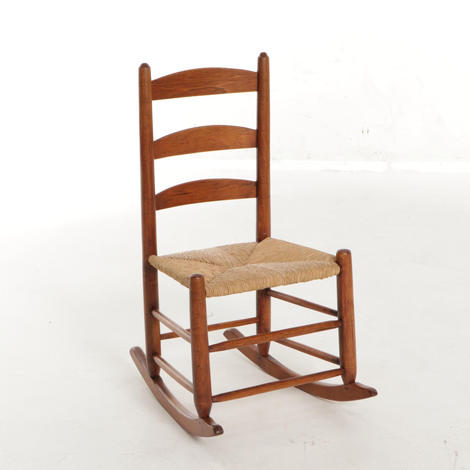 American Primitive Hardwood Ladder-Back Rocking Chair with Rush Seat | EBTH